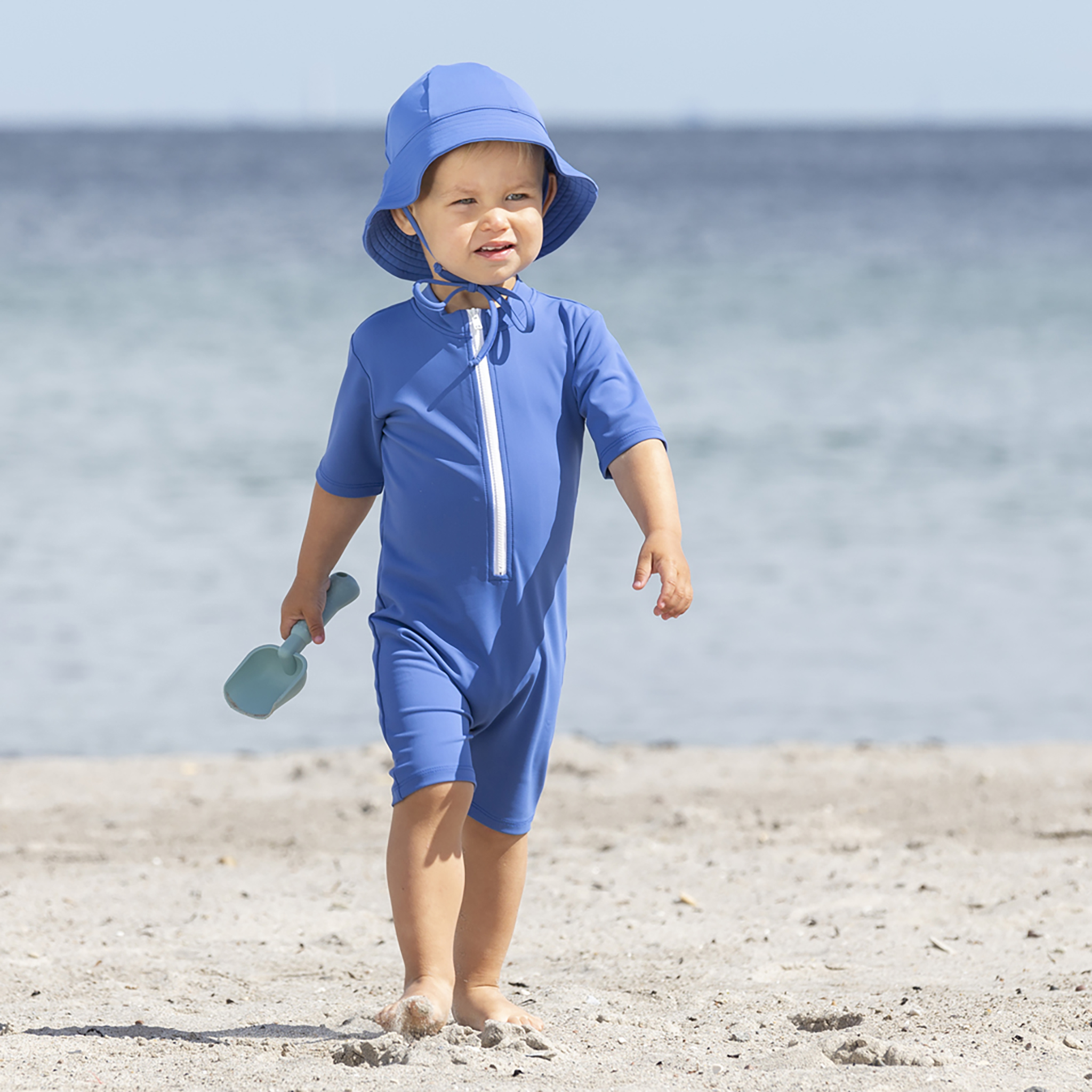 Noe BASIC UV-sunsuit S/S – sapphire - Petit Crabe